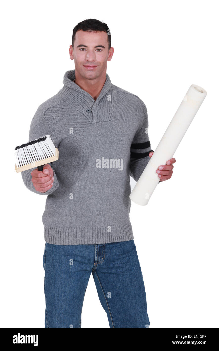 Man putting up wallpaper Stock Photo - Alamy