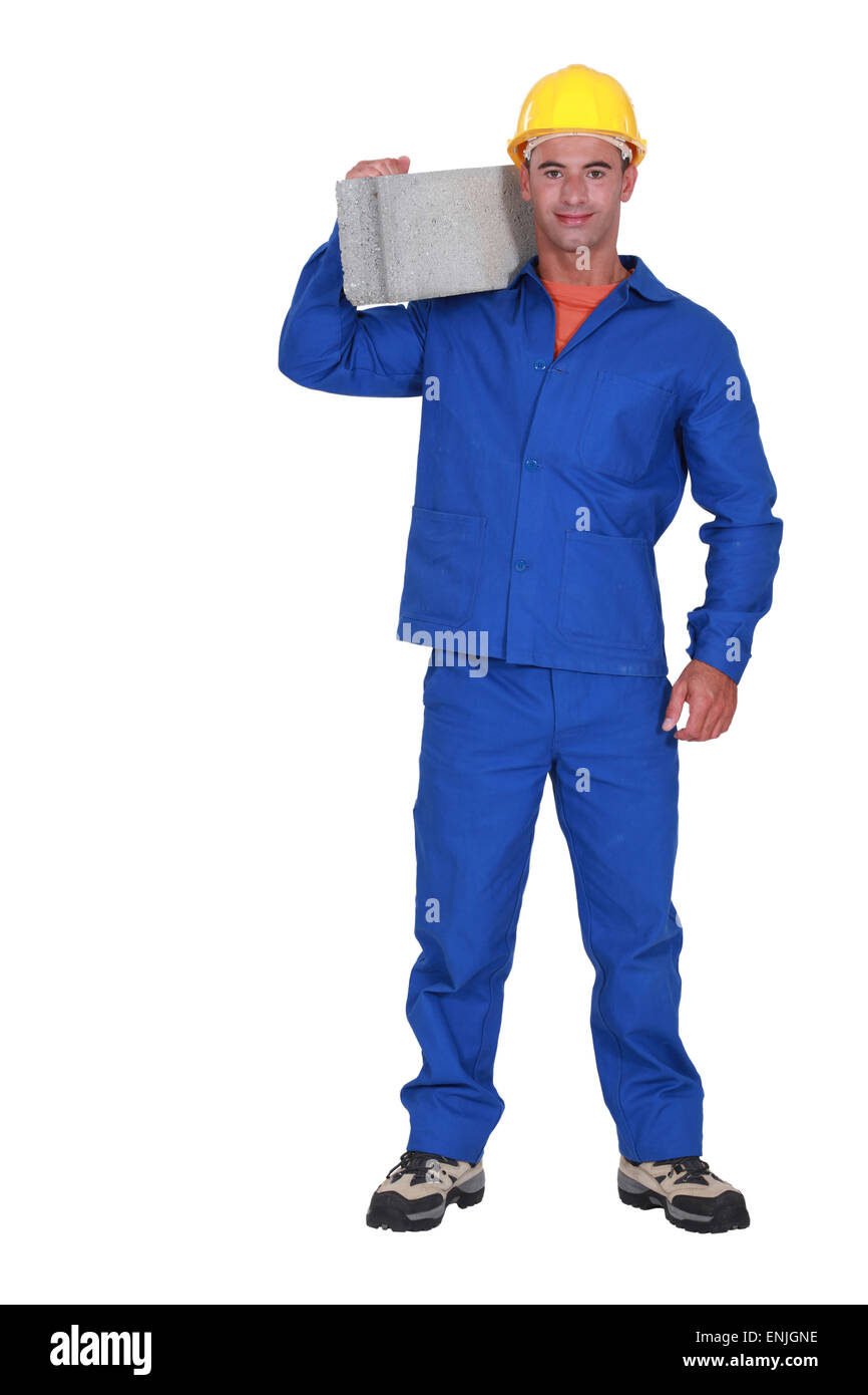 Builder carrying a block Stock Photo - Alamy