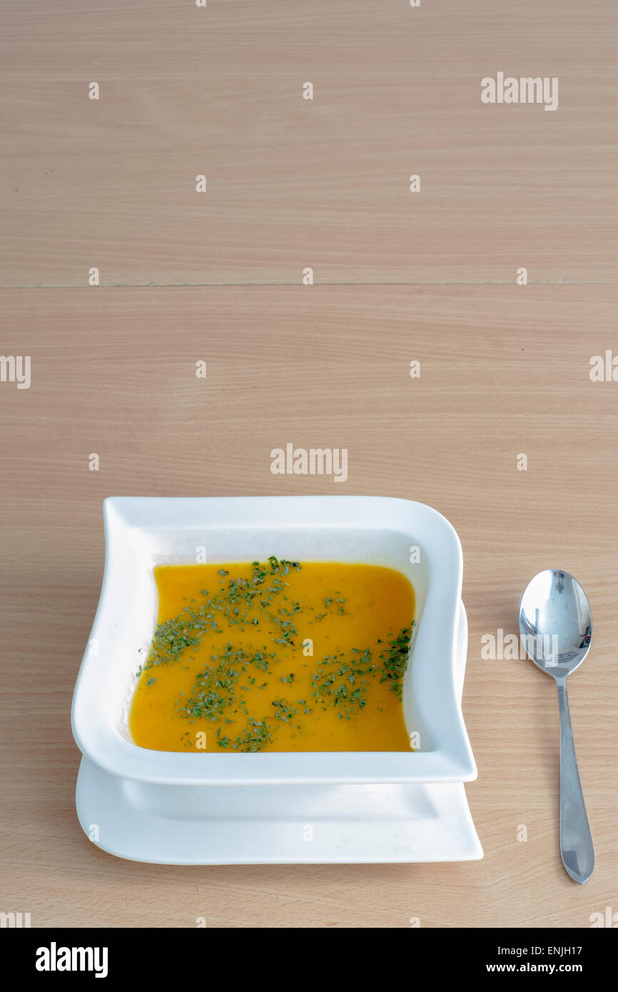 Home made carrot soup with coriander in white square shaped bowl Stock ...