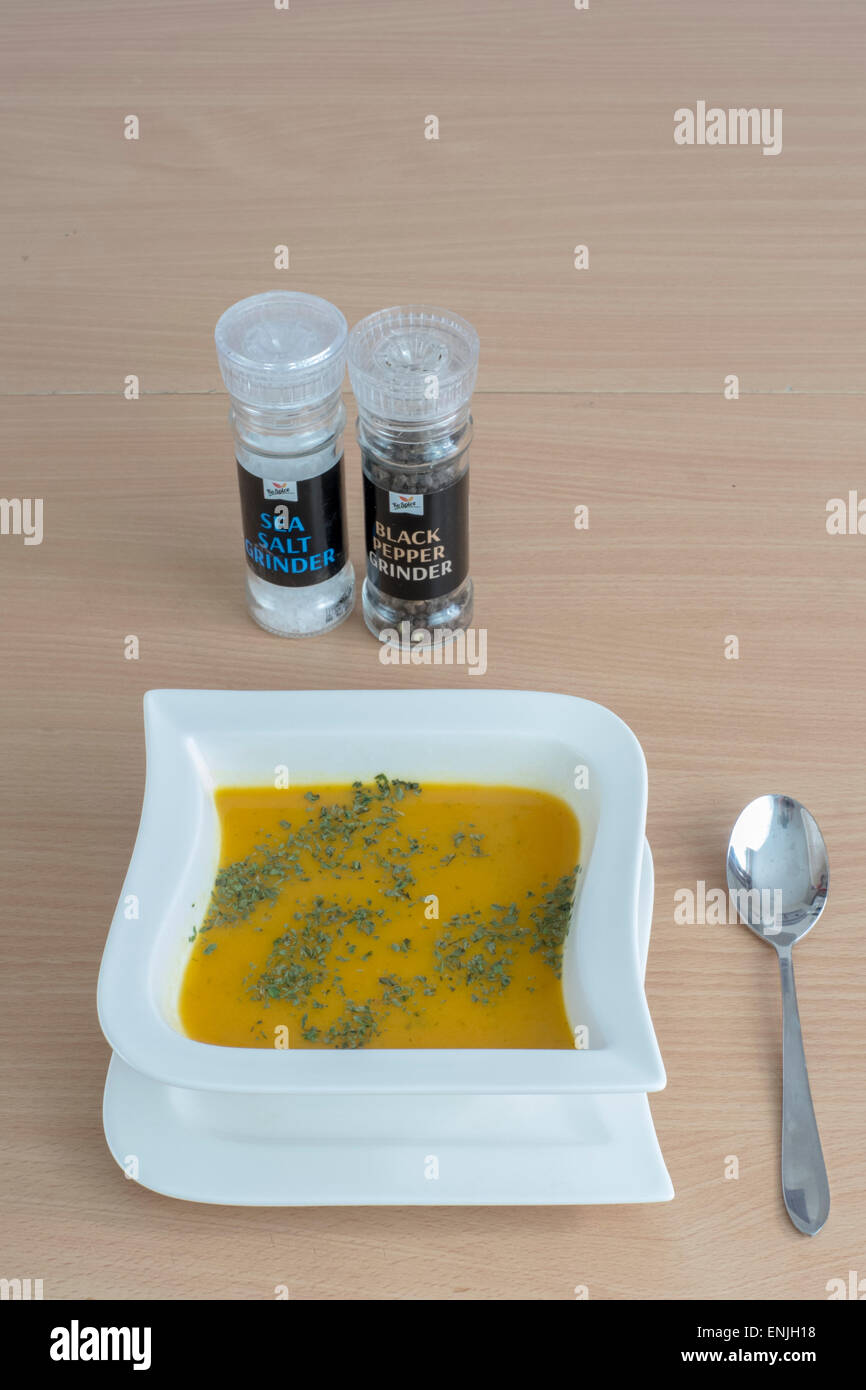 Home made carrot soup with coriander in white square shaped bowl Stock ...