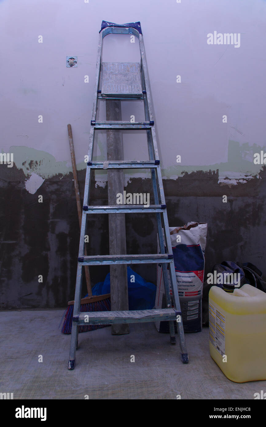 the step ladder and materials for repair stand near a wall Stock Photo ...