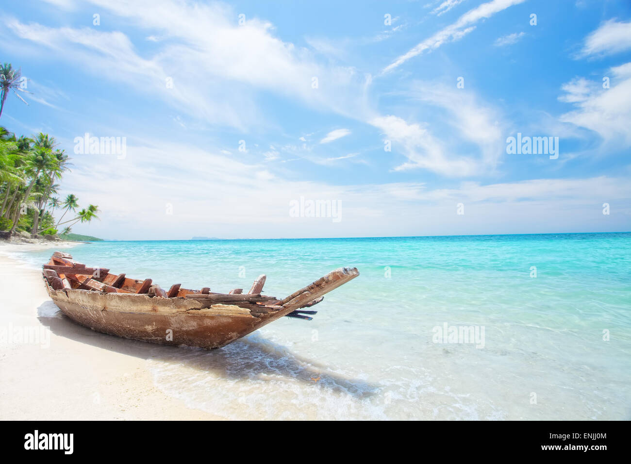 View of nice tropical beach with old boat Stock Photo - Alamy