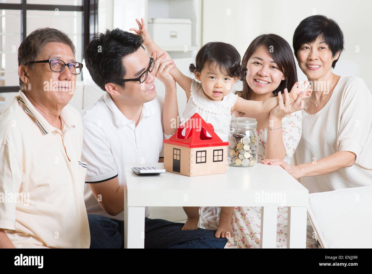 Family money saving or future financial planning concept. Asian multi generations lifestyle at ...