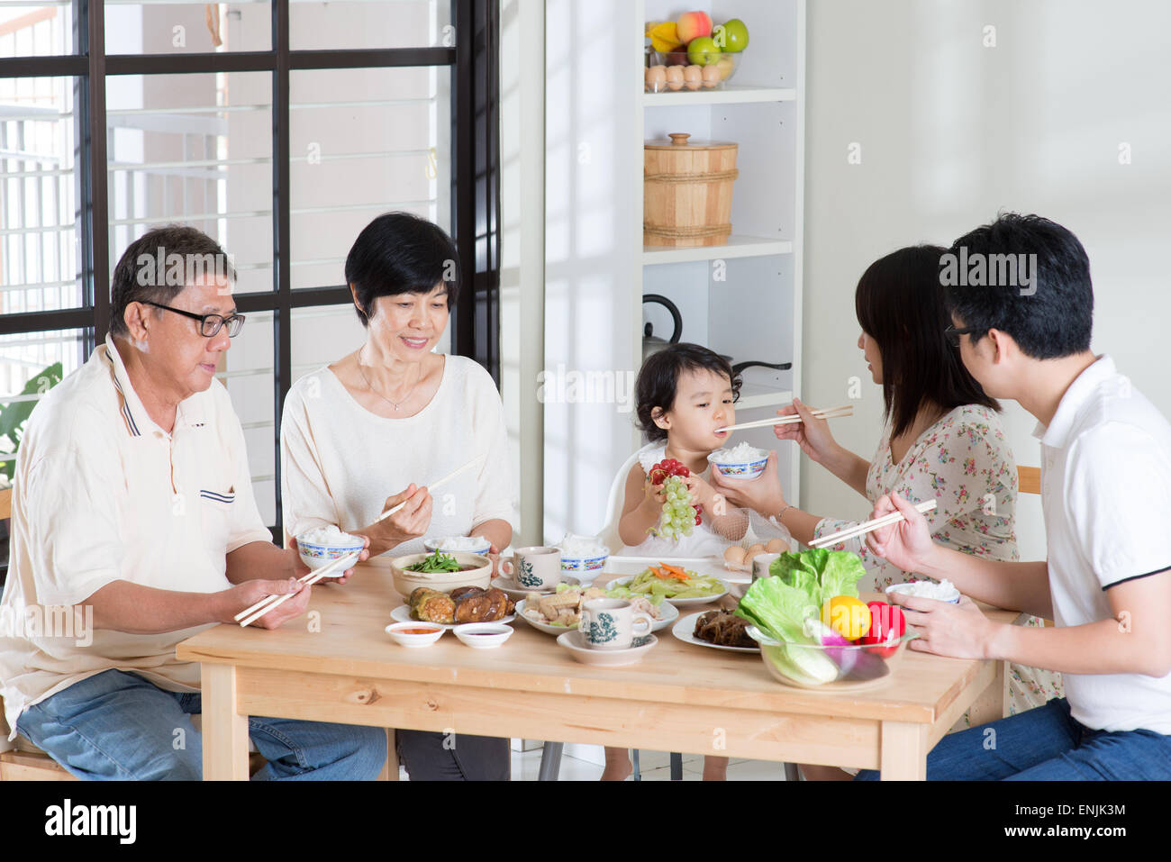 Asian family eating at home. Multi generation having meal, living ...
