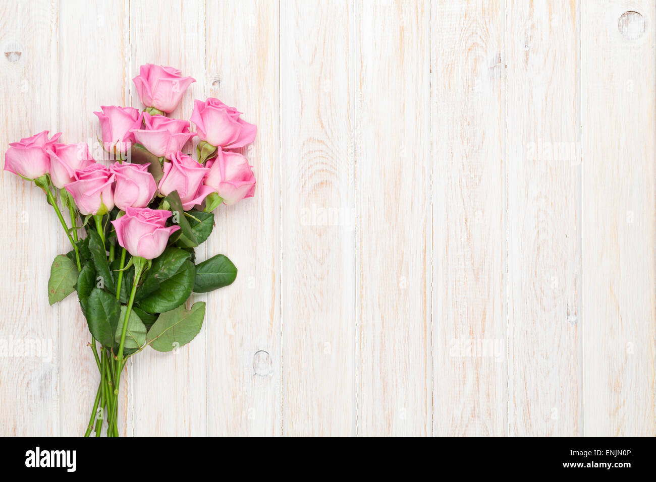 Pink roses bouquet over wooden table. Top view with copy space Stock ...