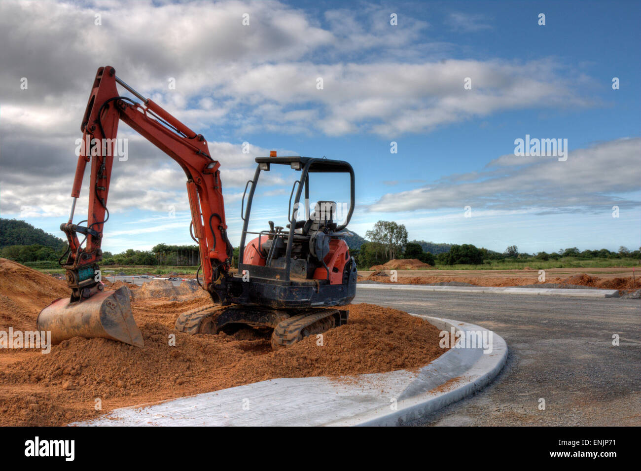 a digger in a new development area constructing road Stock Photo - Alamy