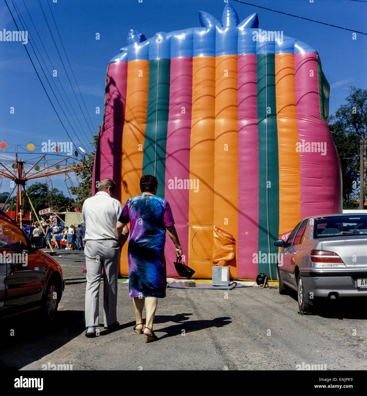 Rural funfair, inflatable bouncy castle in typical rural village fair ...