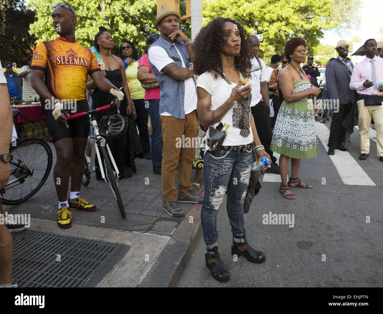 Bystanders watch street performance at The Dance Africa Festival in the ...