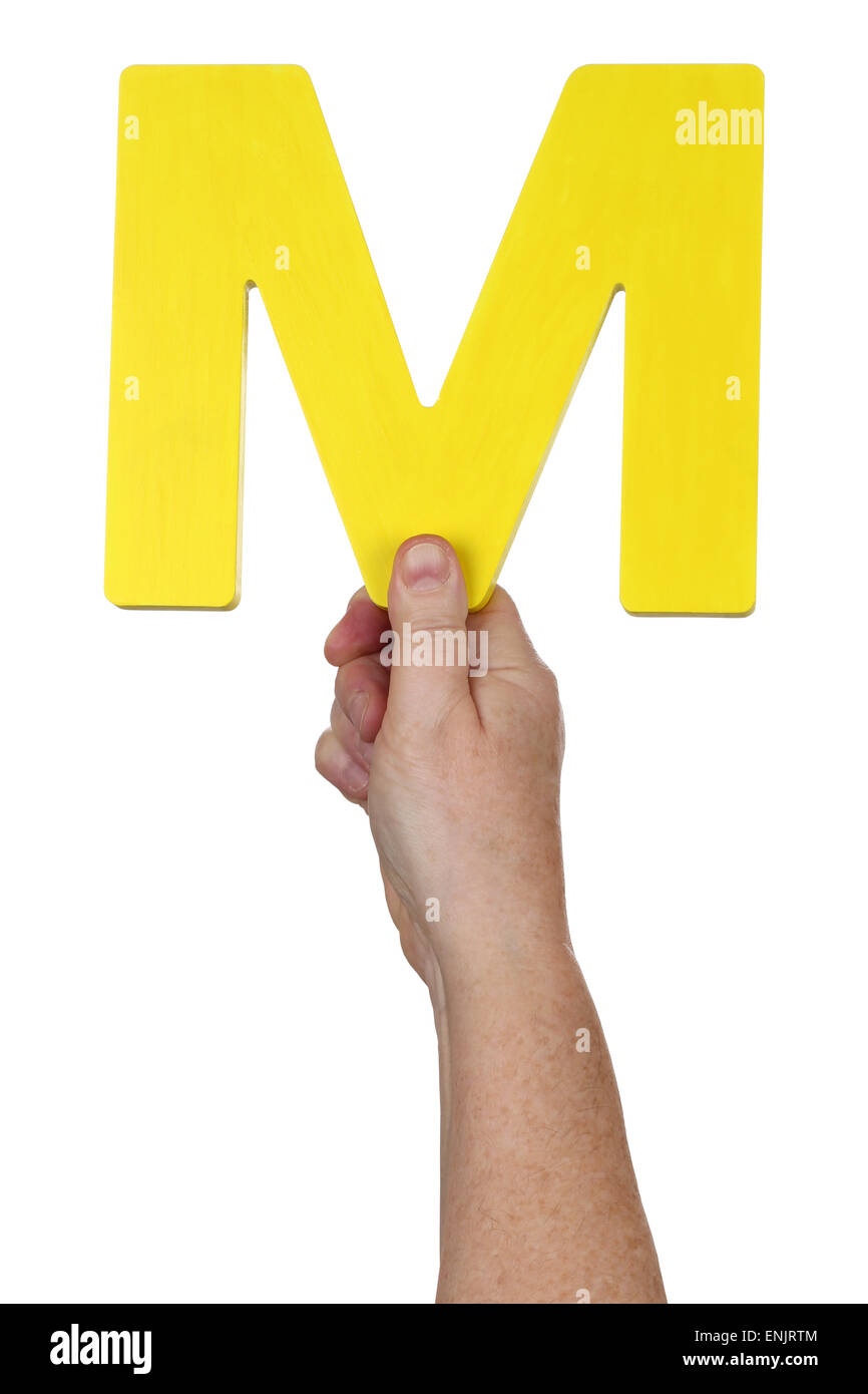 Hand holding letter M from alphabet isolated on a white background ...
