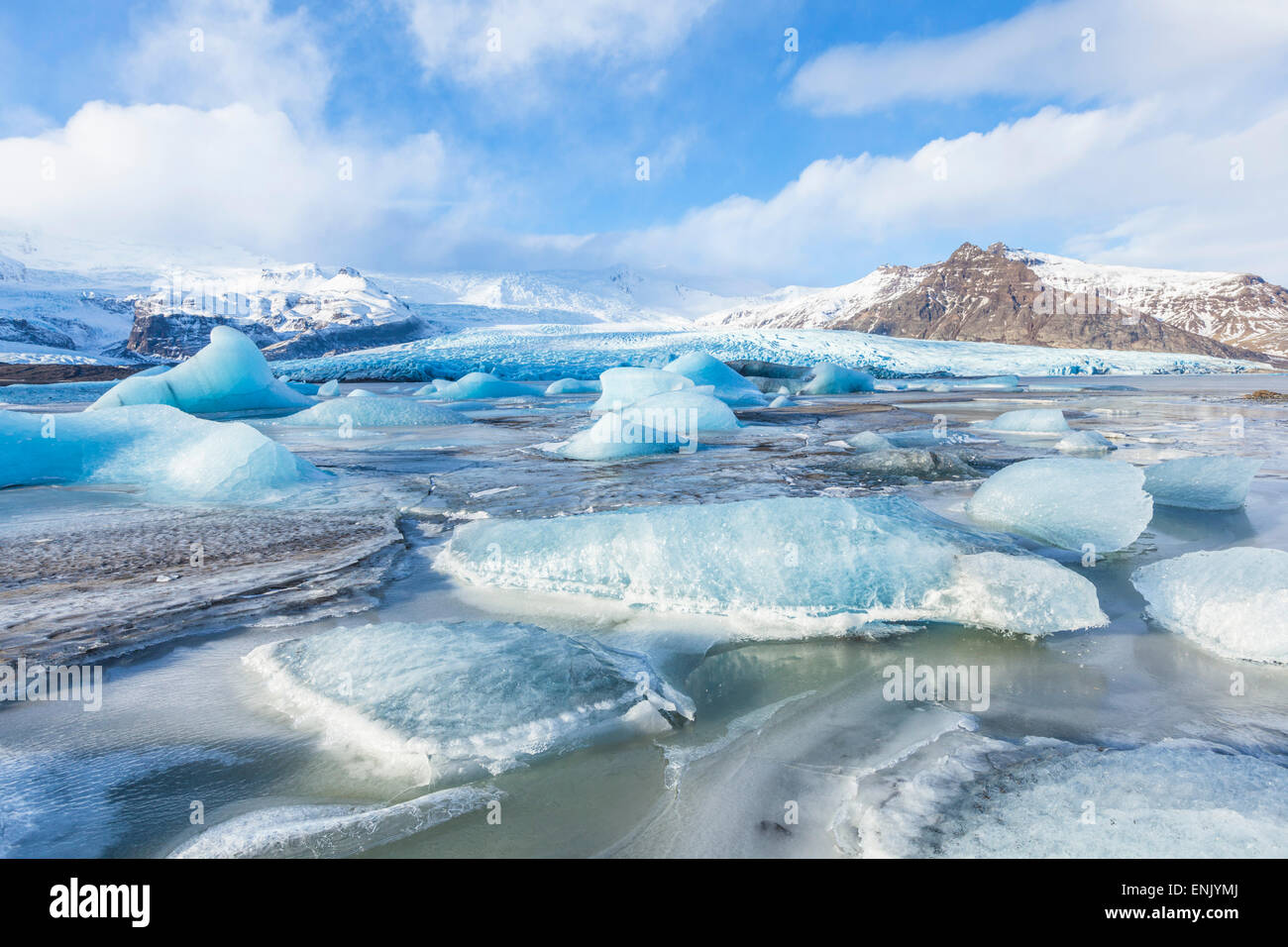 Frozen icebergs locked in the frozen waters of Fjallsarlon Glacier ...