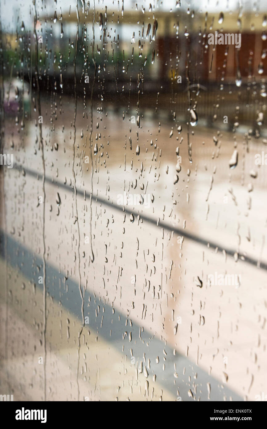 Looking out of a rain drop covered railway carriage window Stock Photo ...