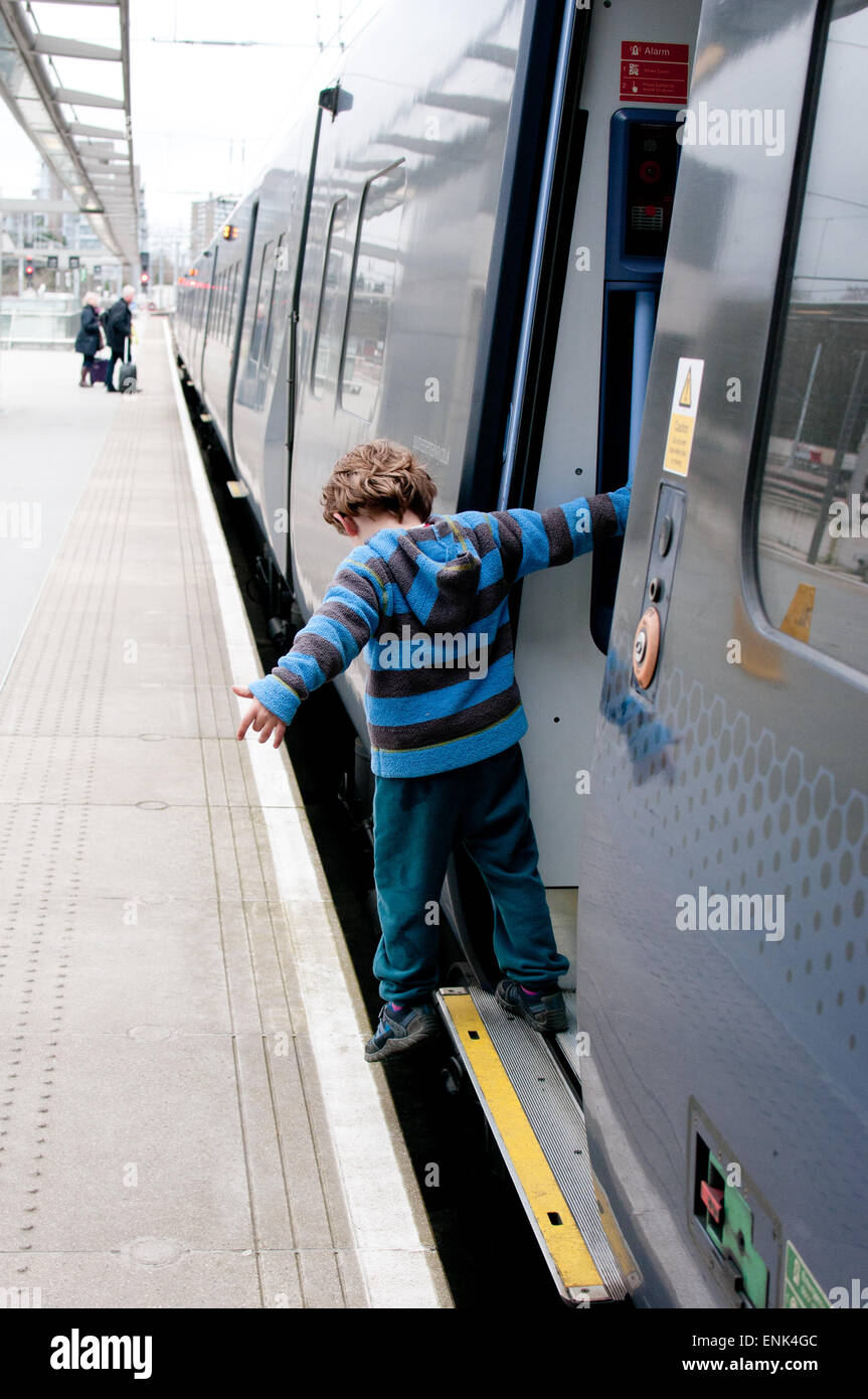 boy stepping off from a train door Stock Photo - Alamy
