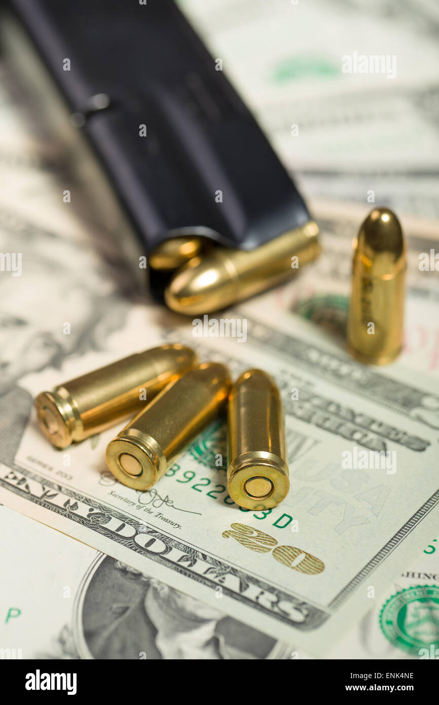 detail of bullet on US dollar banknotes, crime or corruption concept ...
