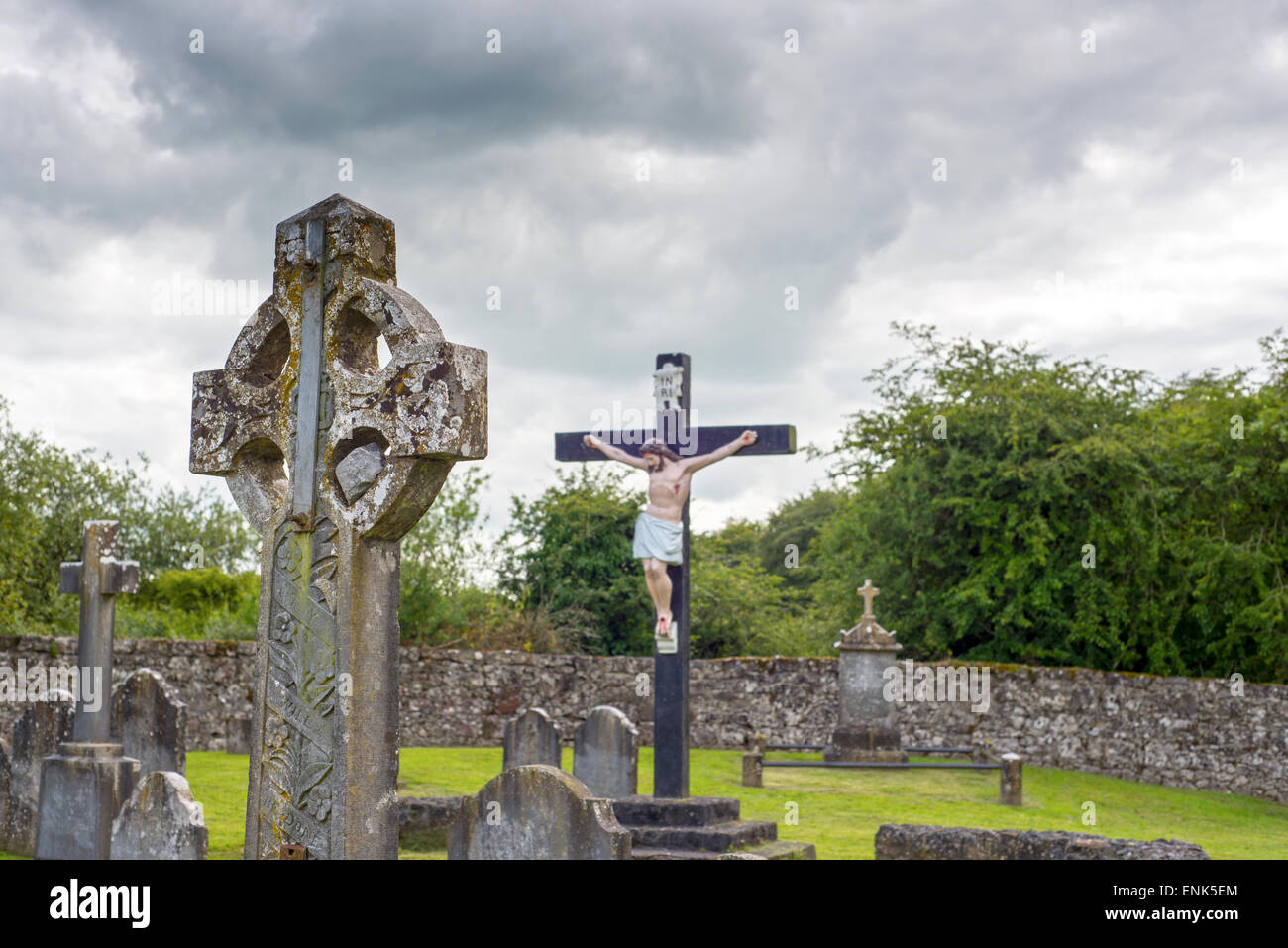 celtic cross headstone and crucifix in a graveyard in county tipperary ...