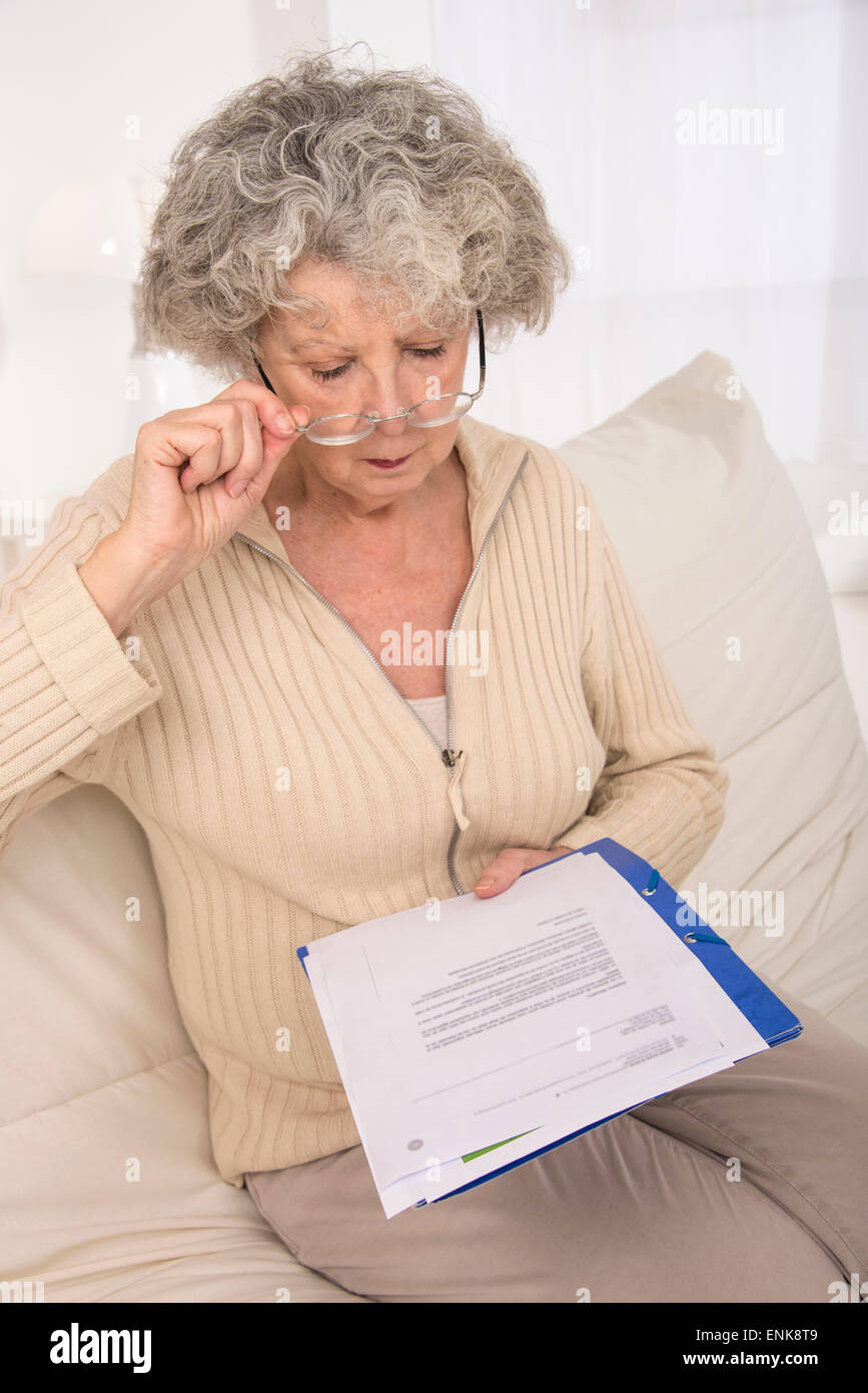 Elderly person doing paperwork Stock Photo - Alamy