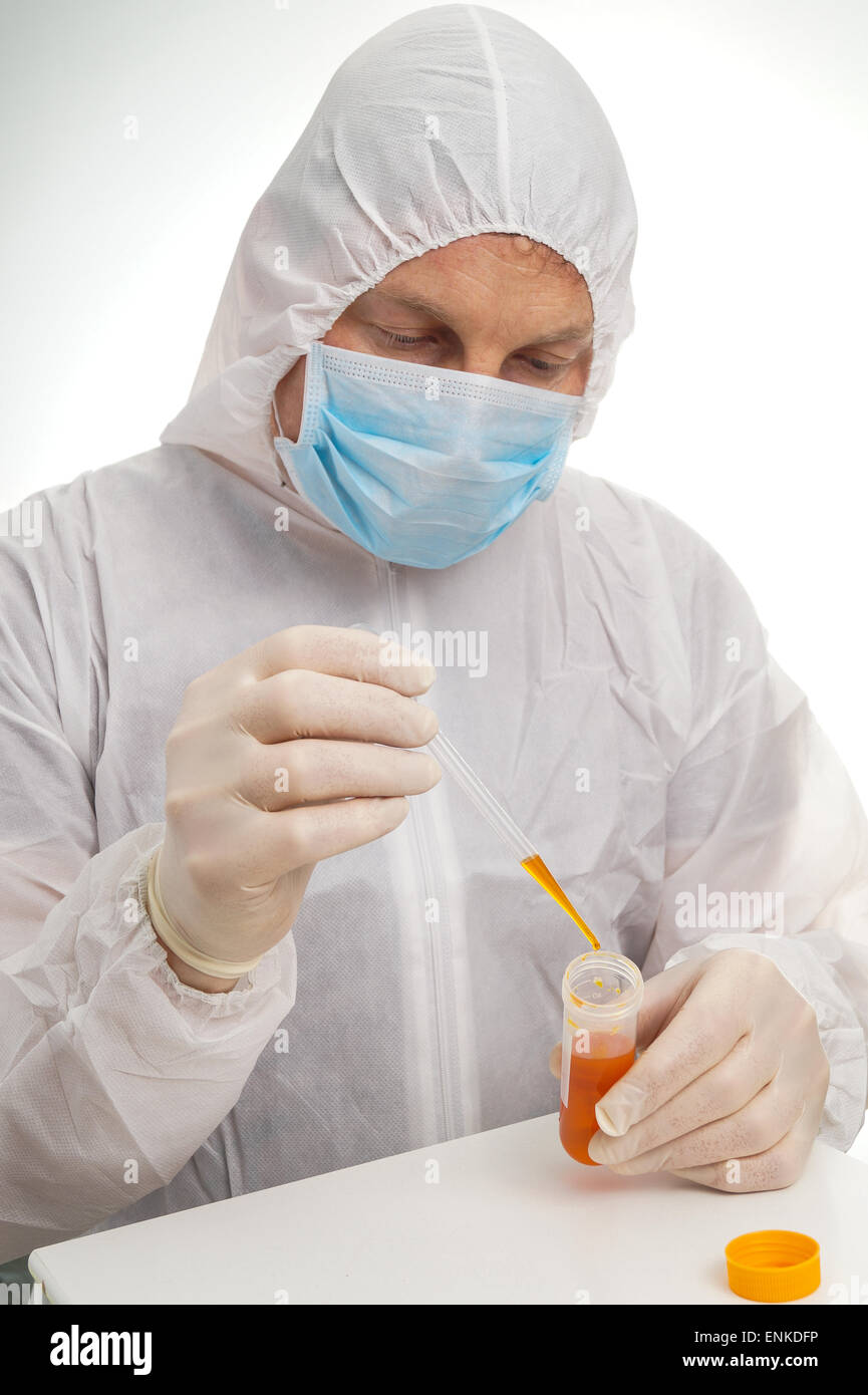 Man testing lab sample in protective suit and mask Stock Photo - Alamy