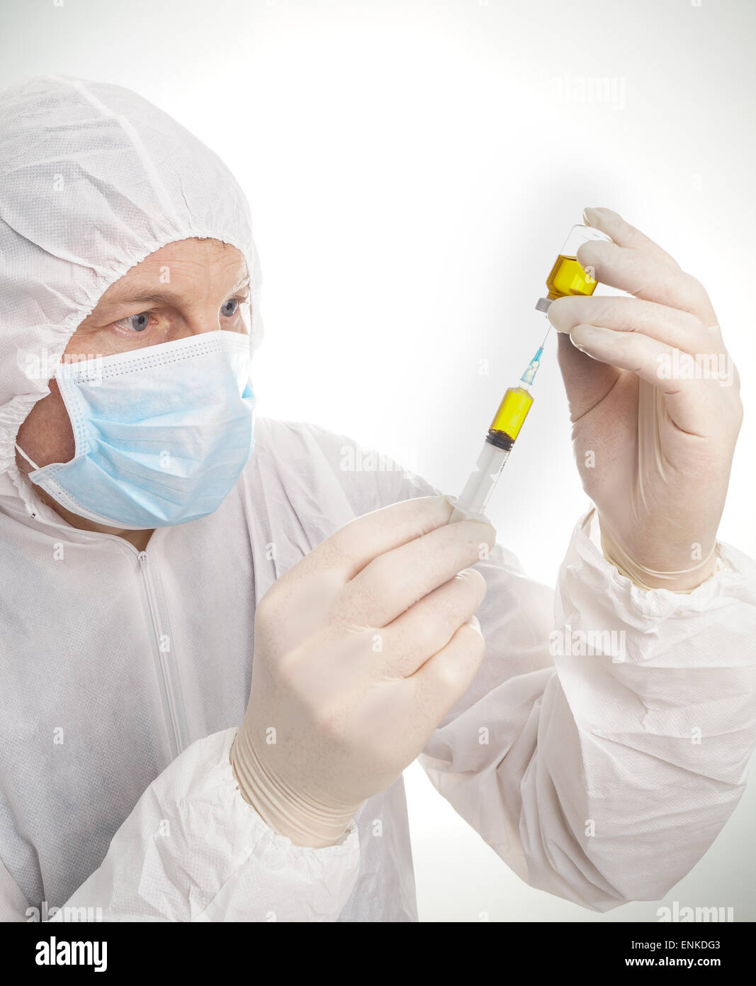 Man with syringe and vial in protective suit and mask Stock Photo - Alamy