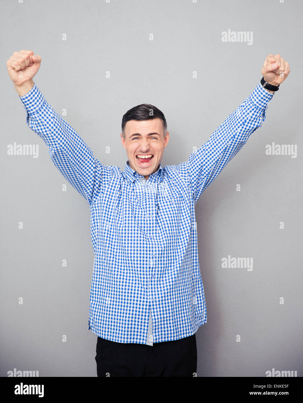 Man raised hands up and screaming. Making victory gesture. Looking at ...