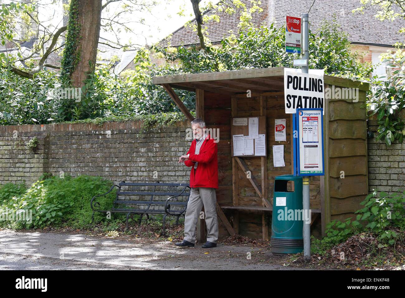 A man waits for a bus in a bus shelter opposite the Polling Station at ...