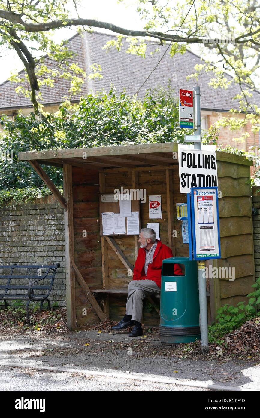 A man waits for a bus in a bus shelter opposite the Polling Station at ...