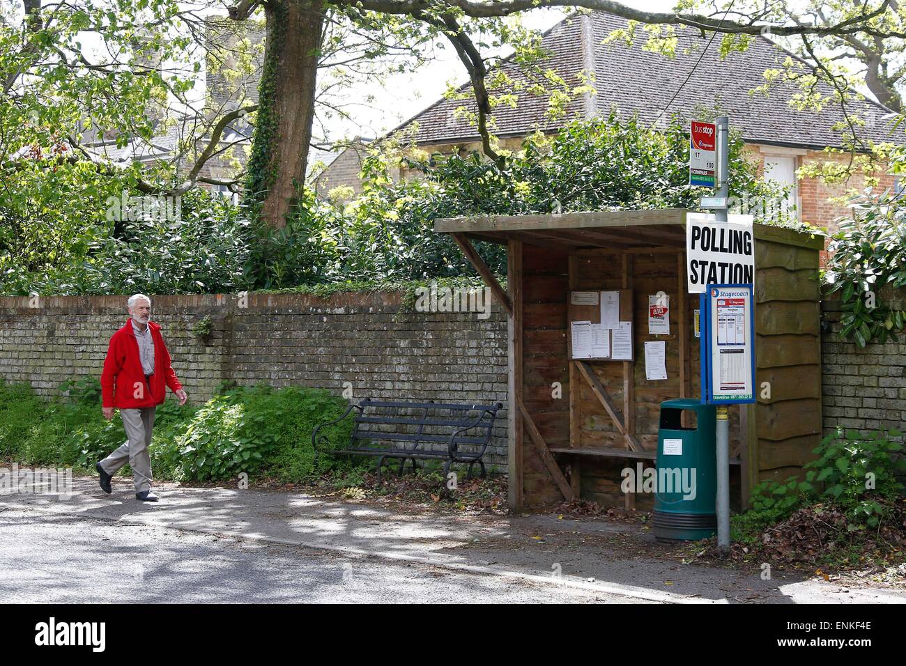 A man waits for a bus in a bus shelter opposite the Polling Station at ...