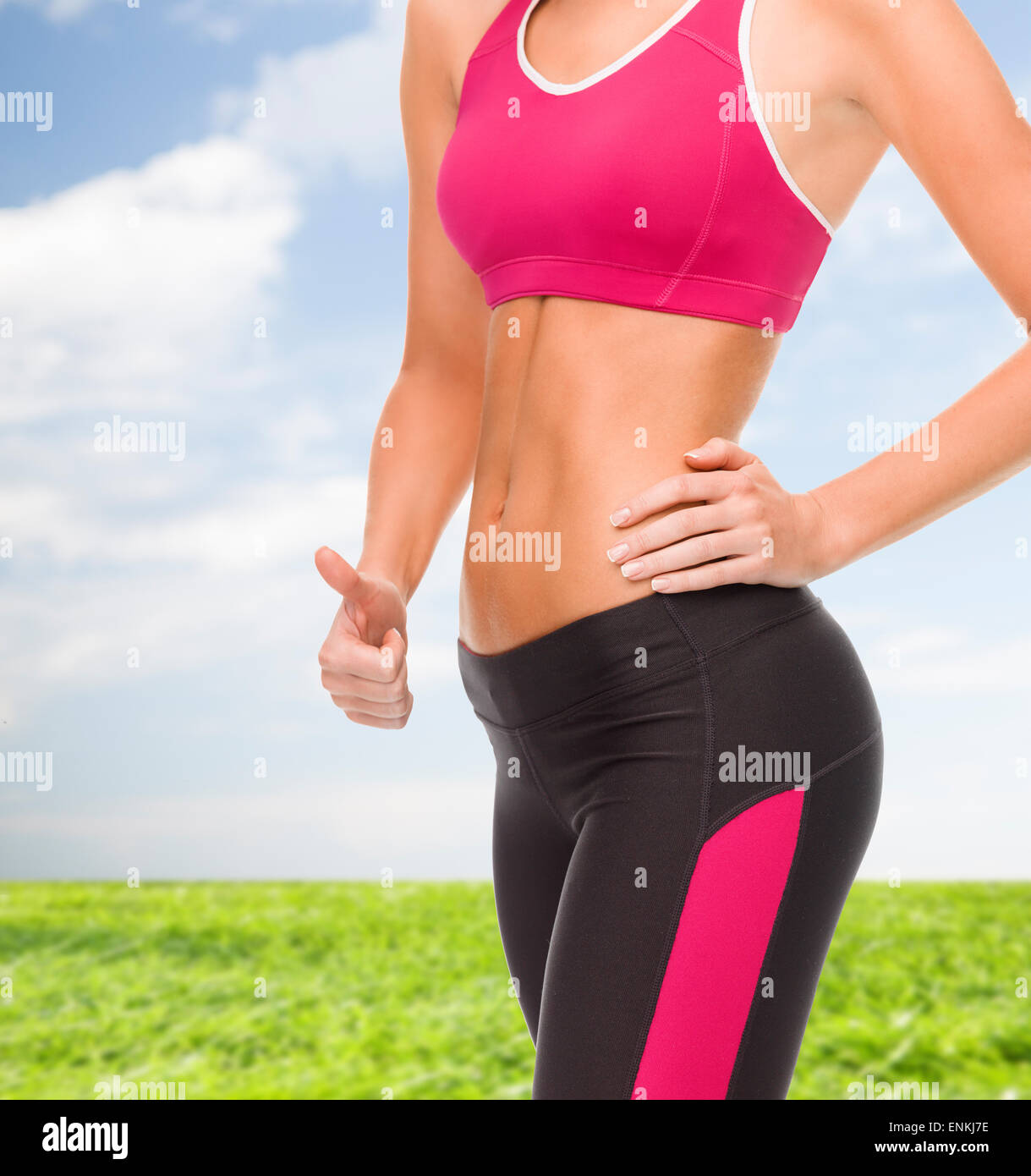 close up of female abs and hand showing thumbs up Stock Photo - Alamy