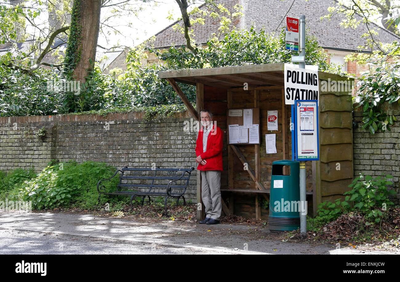 A man waits for a bus in a bus shelter opposite the Polling Station at ...
