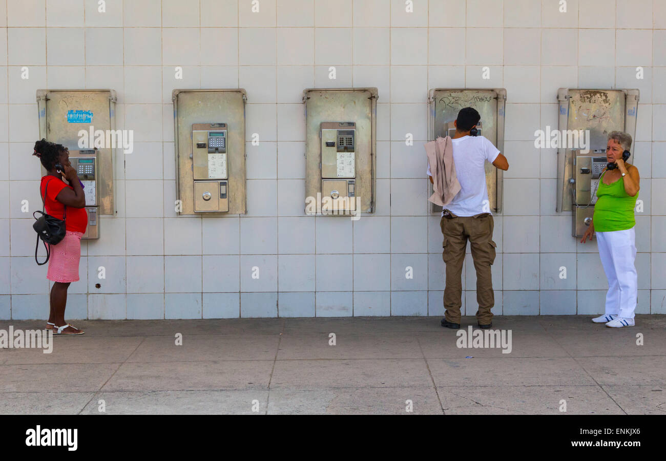 Public pay phones on wall with tiles in Cuba were people are making a ...