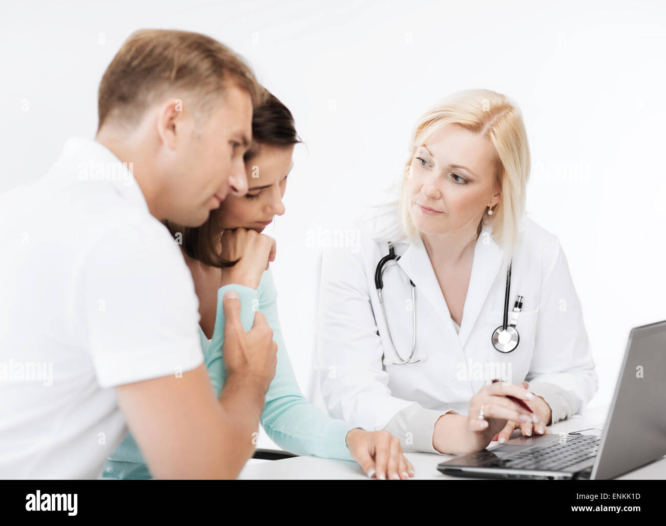 doctor with patients looking at laptop Stock Photo - Alamy