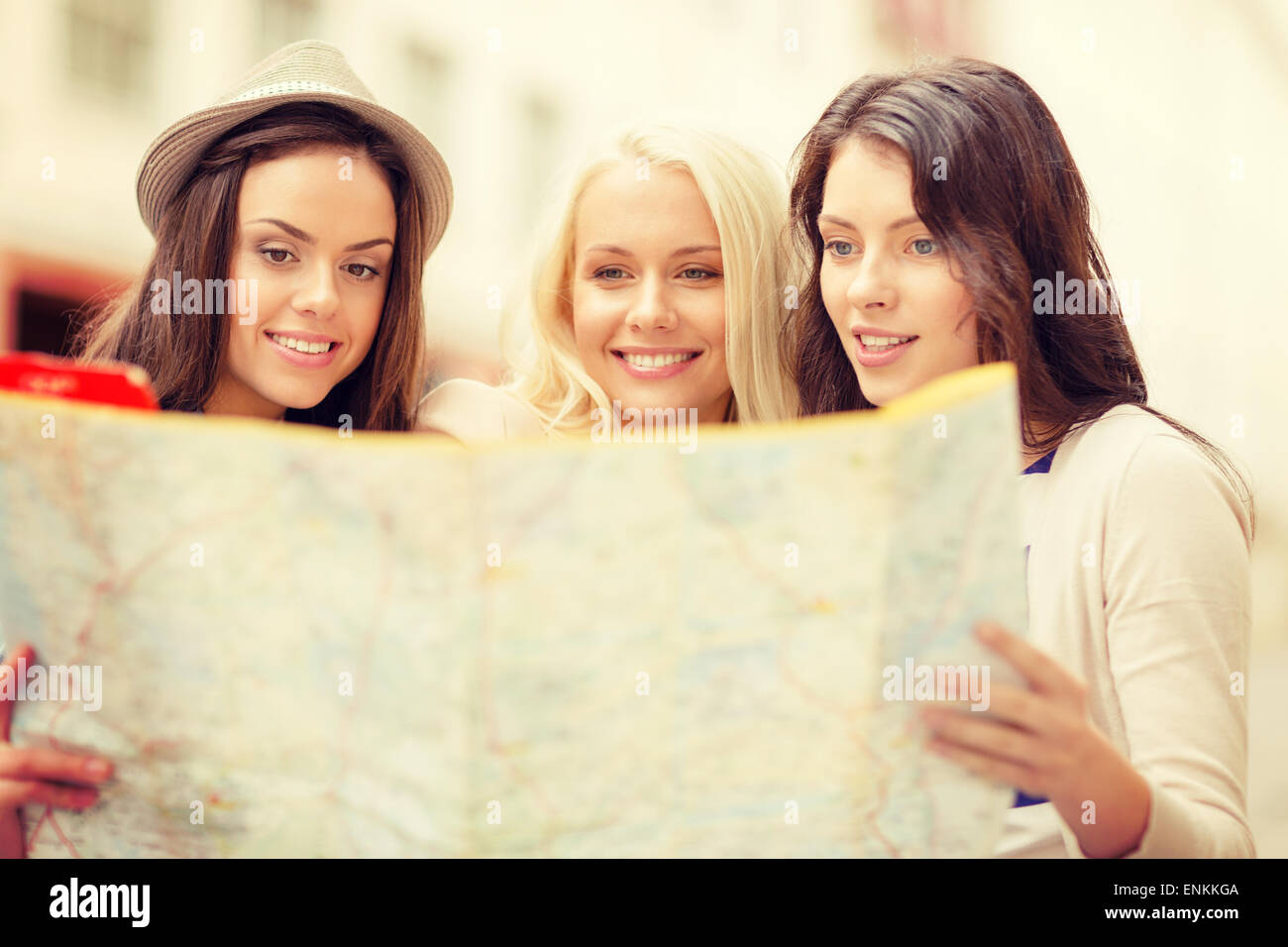 beautiful girls looking into tourist map in city Stock Photo - Alamy