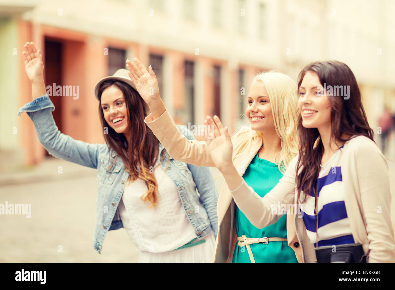 three beautiful girls waving hands Stock Photo - Alamy