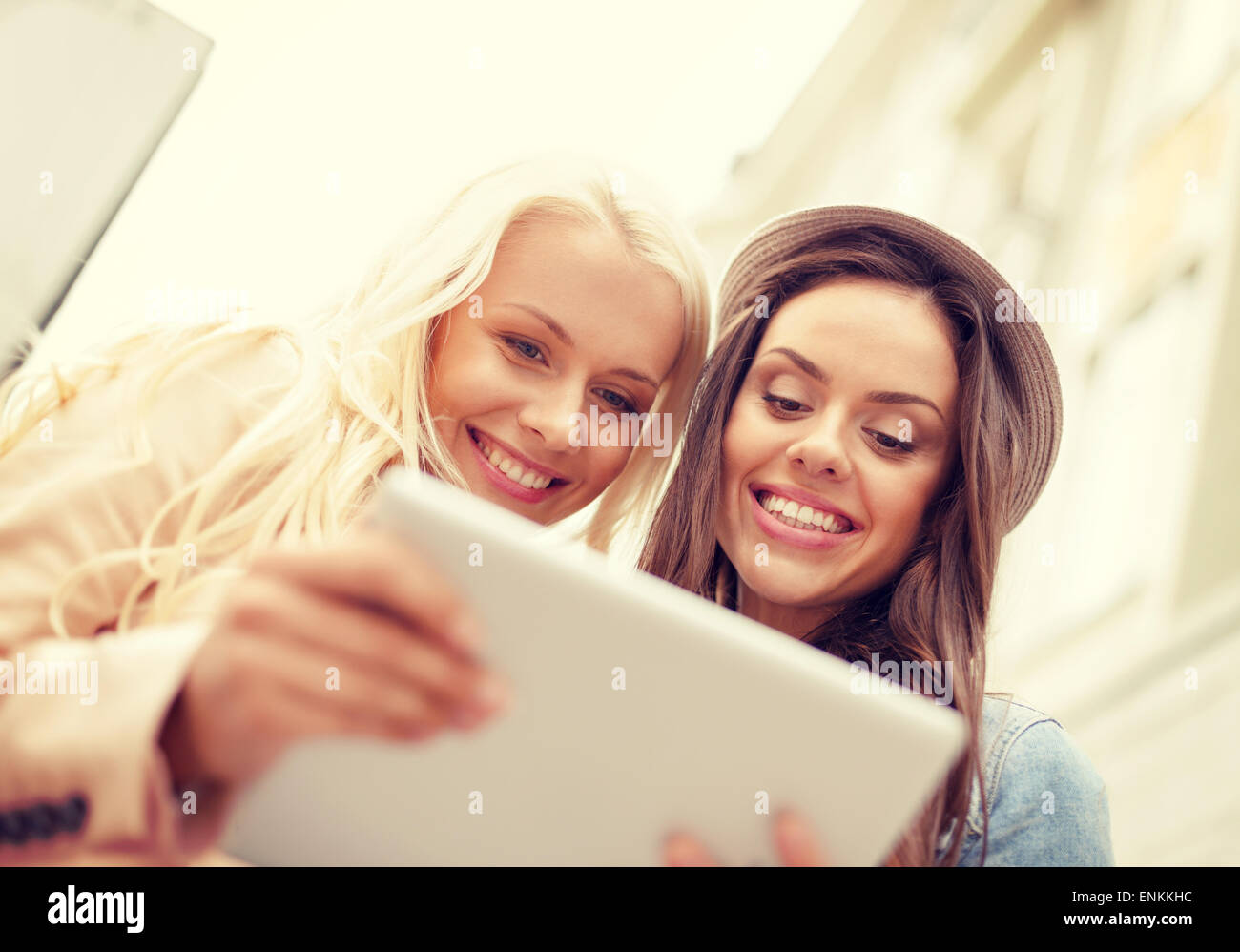 two beautiful girls looking into tablet pc Stock Photo - Alamy