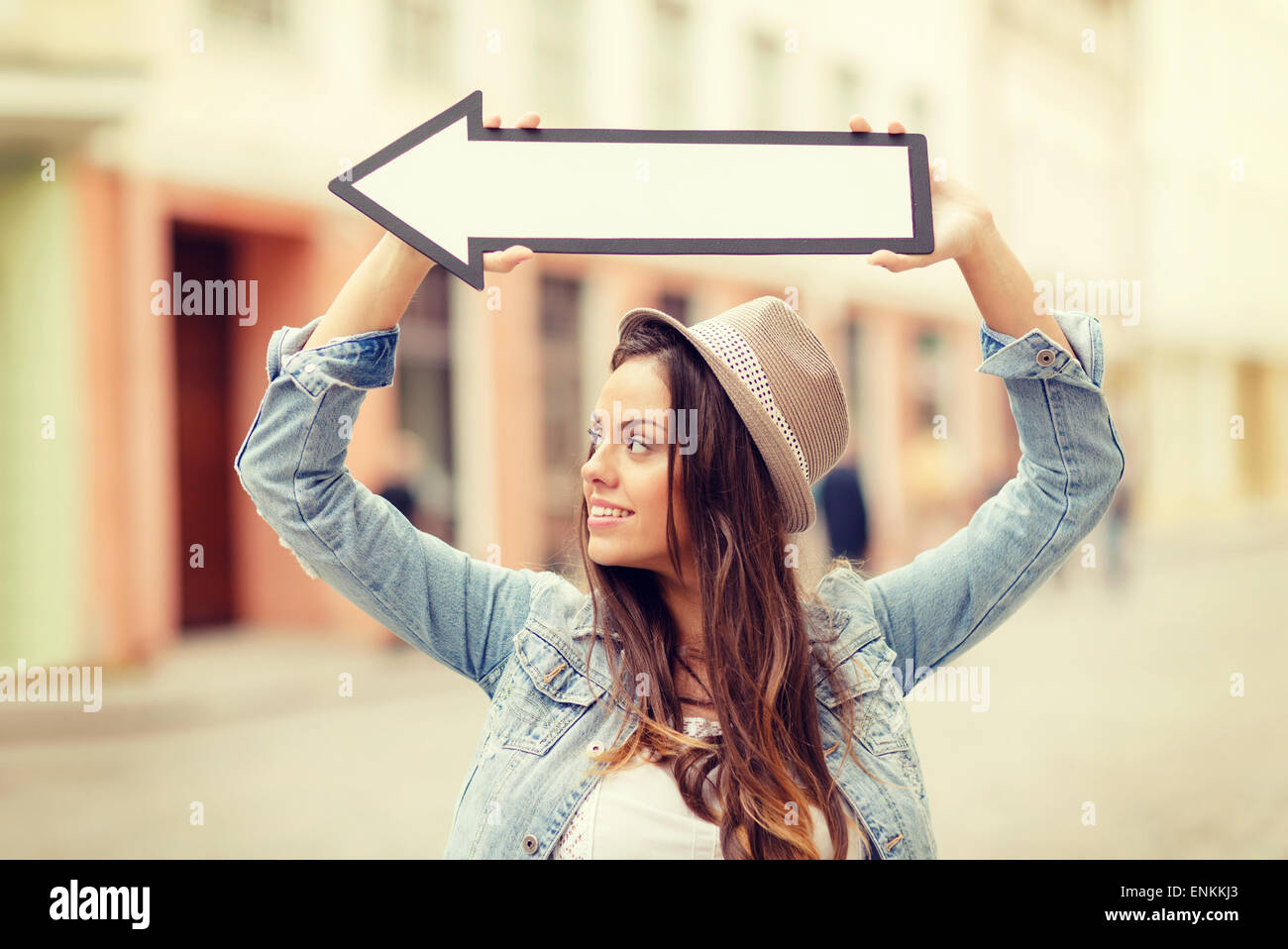 Girl showing direction arrow in hi-res stock photography and images - Alamy