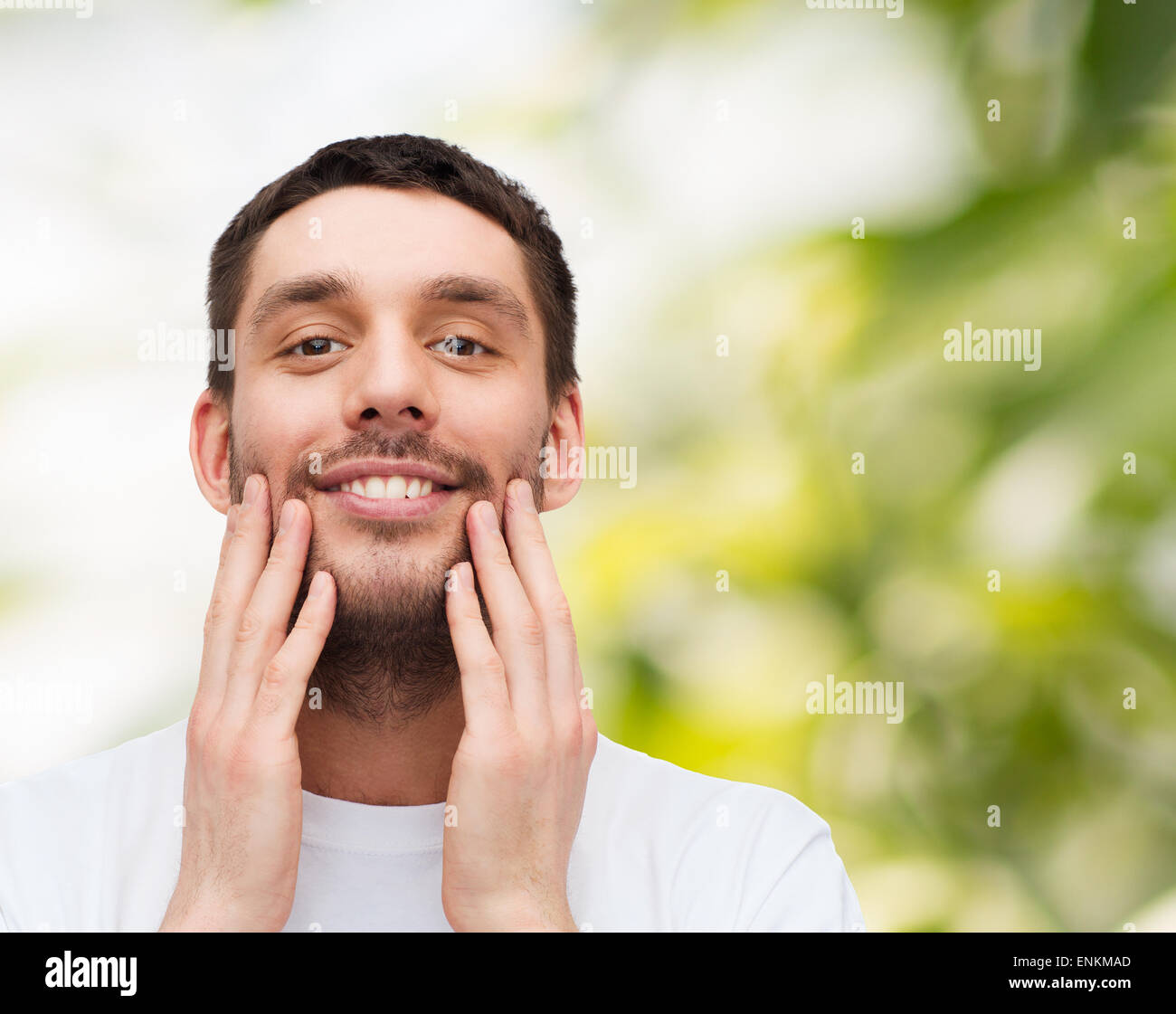 beautiful smiling man touching his face Stock Photo - Alamy