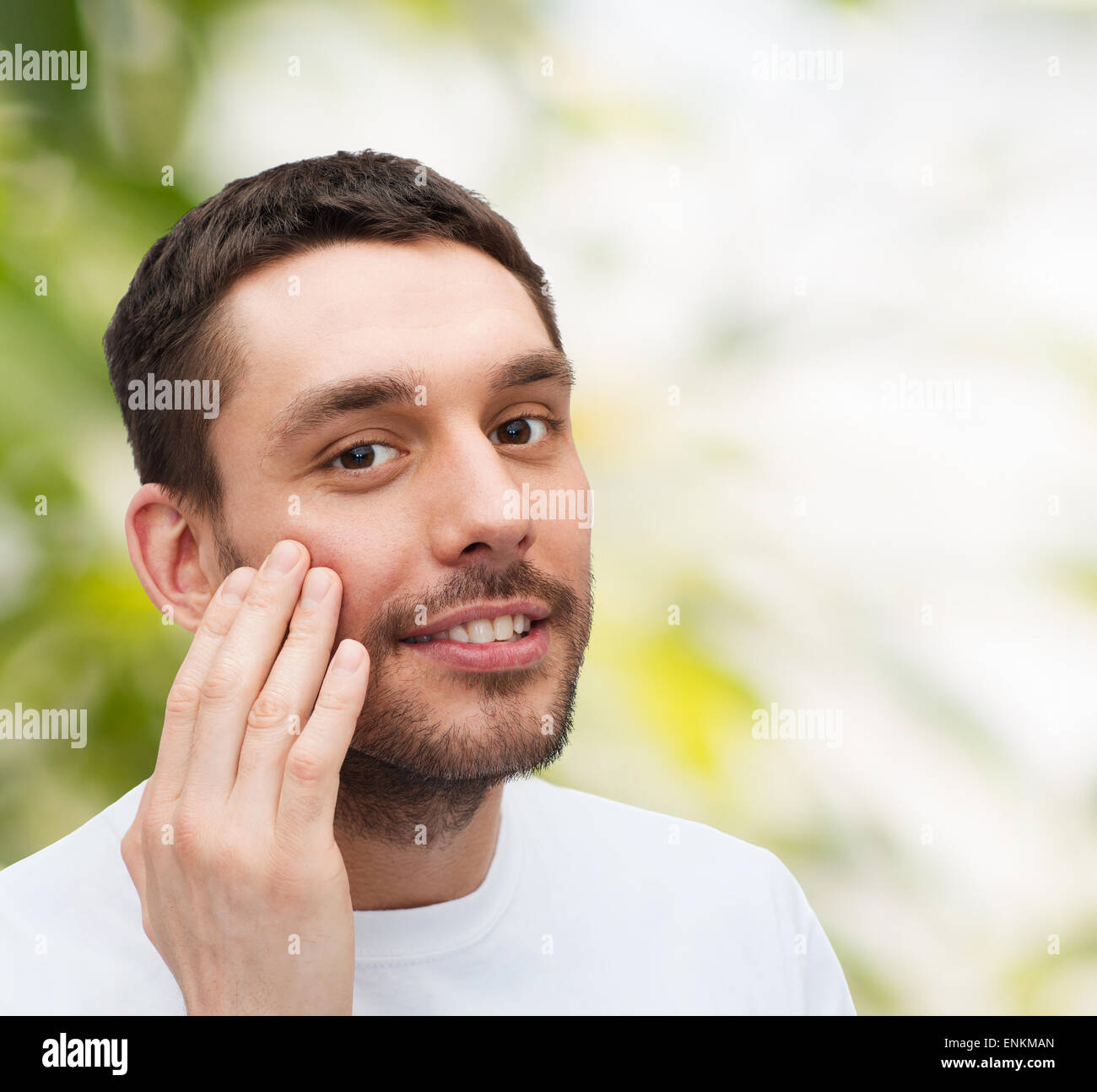 beautiful smiling man touching his face Stock Photo - Alamy