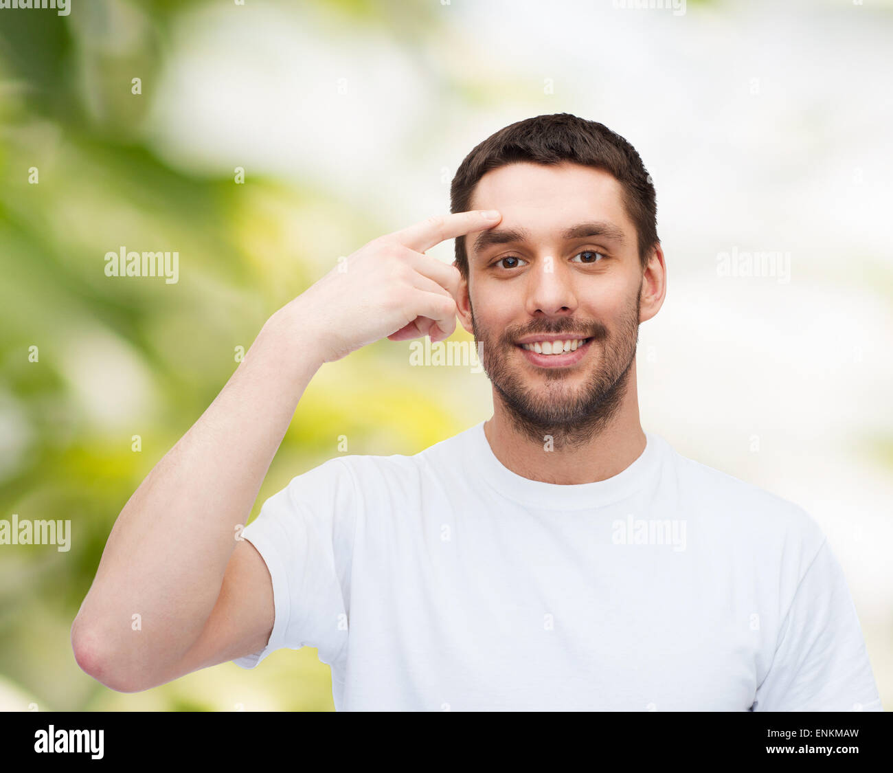 smiling young handsome man pointing to forehead Stock Photo - Alamy