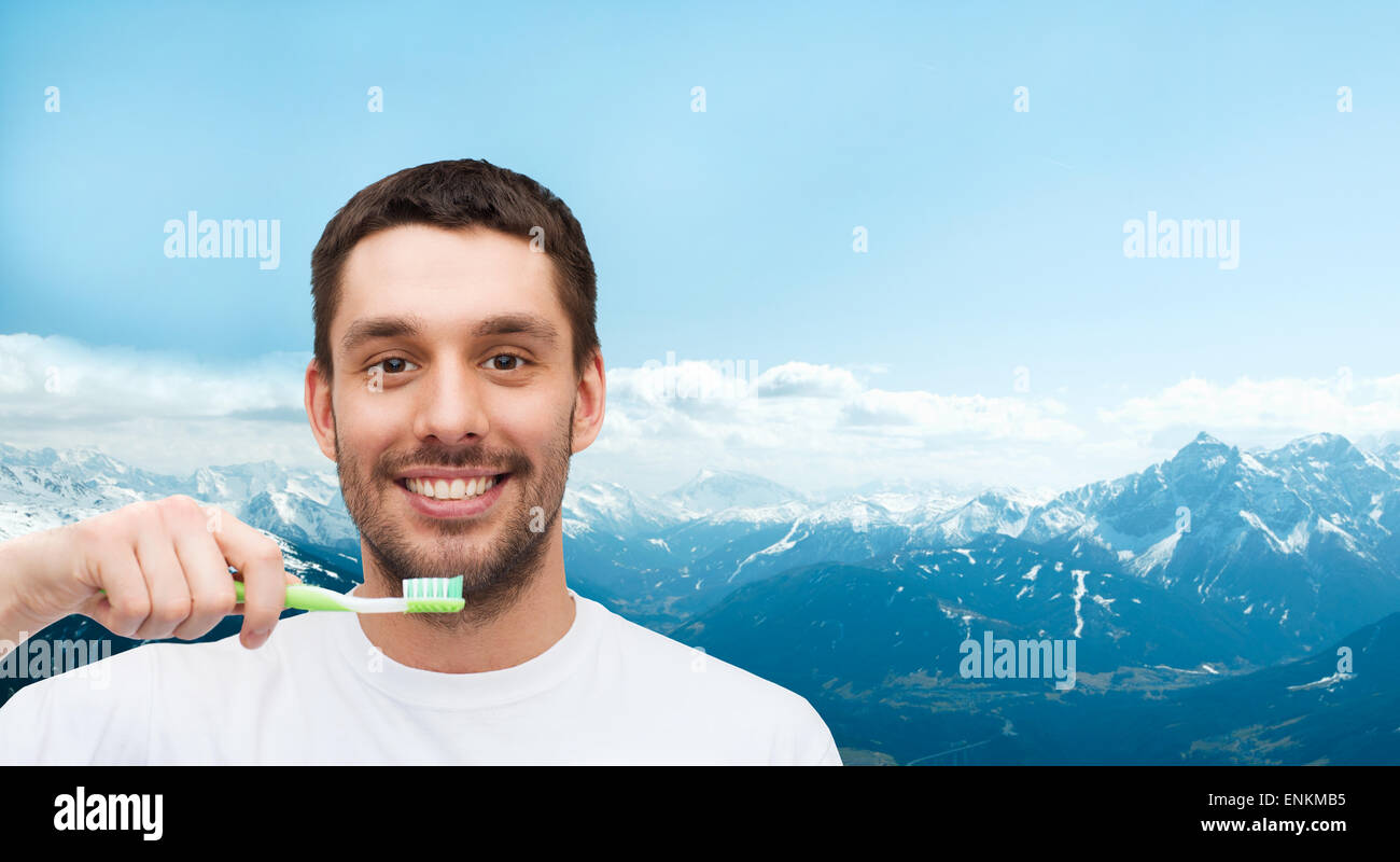 smiling young man with toothbrush Stock Photo - Alamy