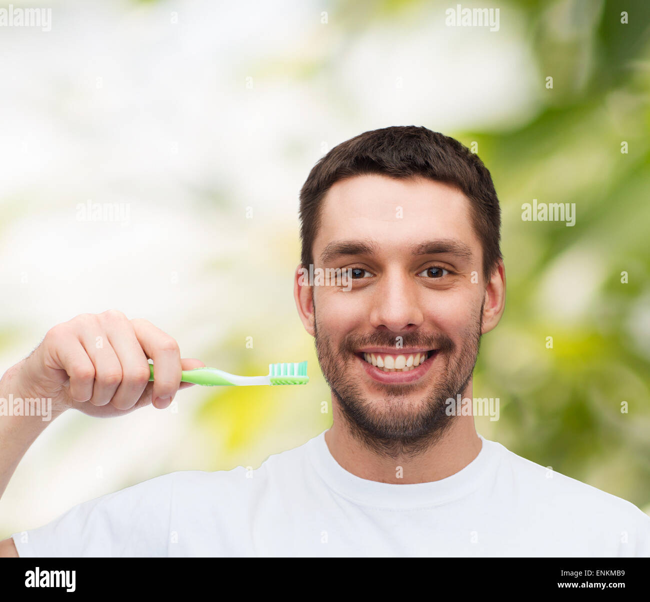 smiling young man with toothbrush Stock Photo - Alamy
