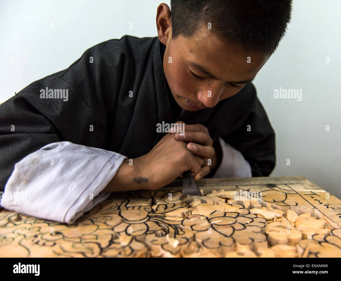 Young man carving wooden panel at Choki traditional art school Kabesa ...
