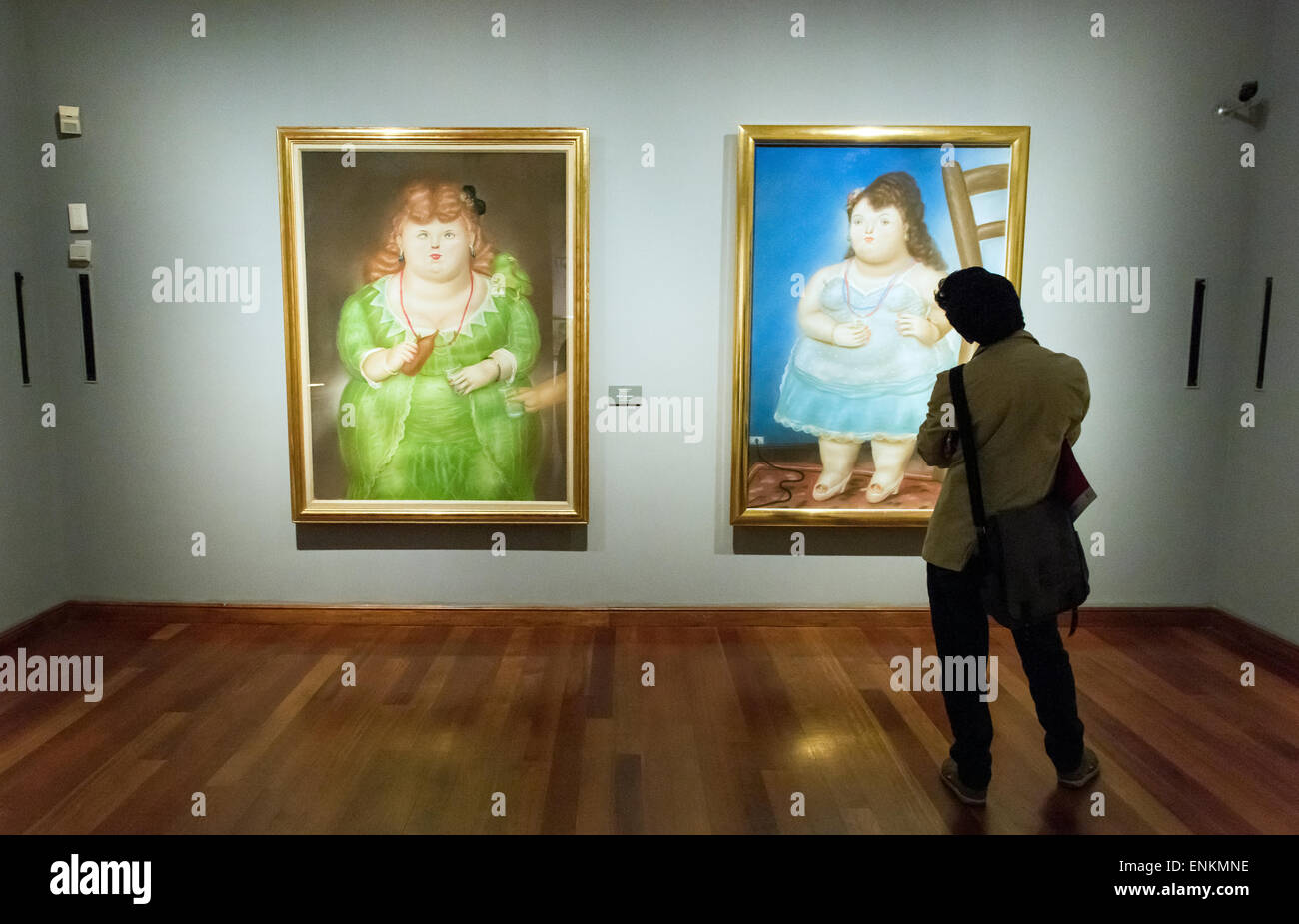 Visitor by paintings by Fernando Botero at Botero Museum Bogota ...