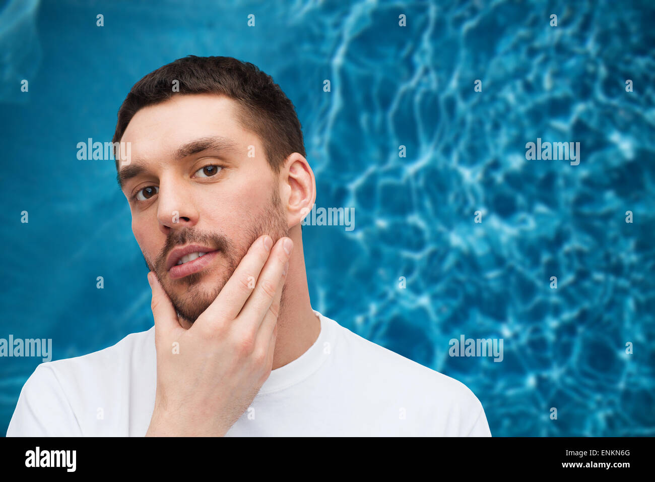 beautiful calm man touching his face Stock Photo - Alamy
