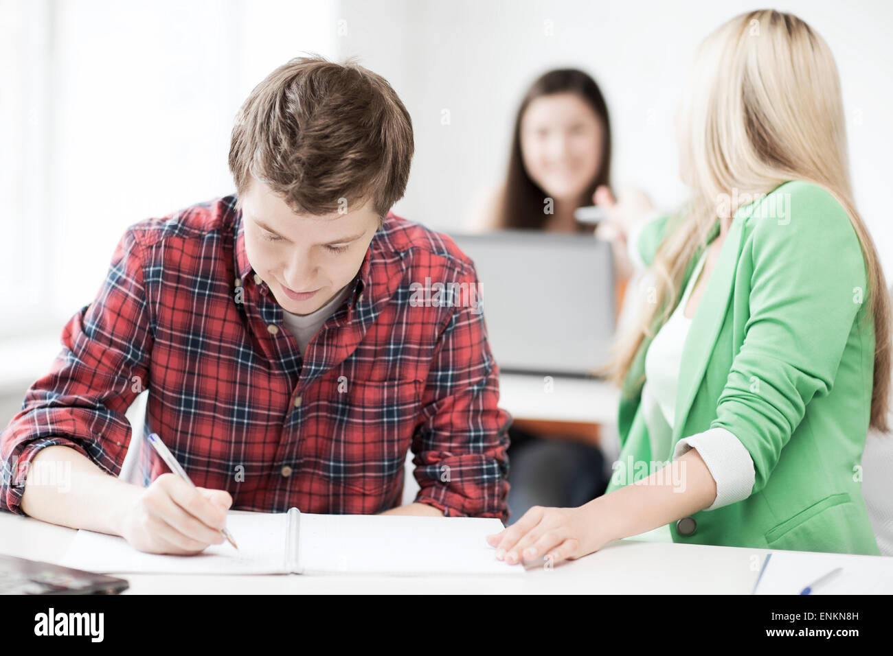 students writing something at school Stock Photo - Alamy