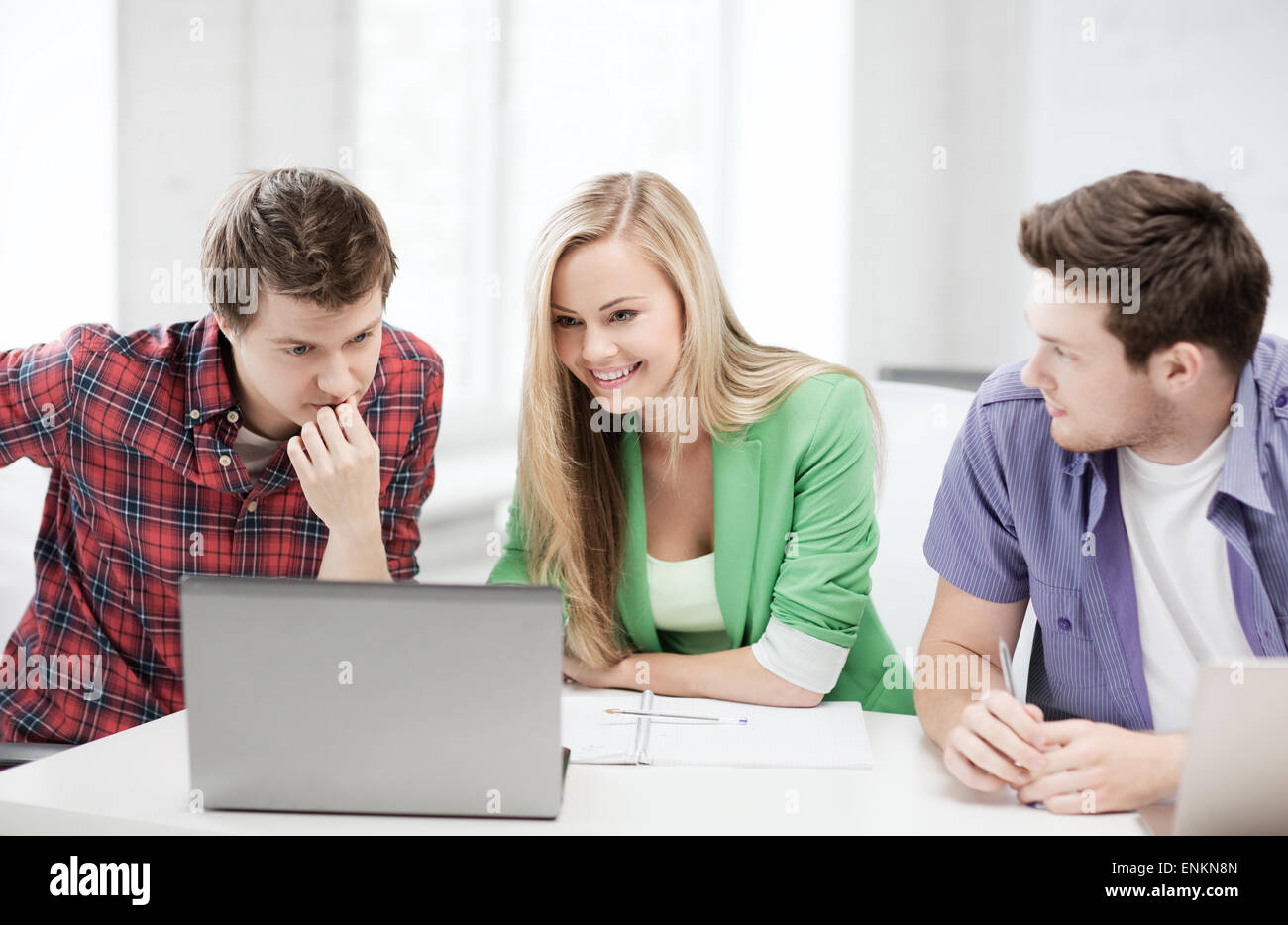 smiling students looking at laptop at school Stock Photo - Alamy