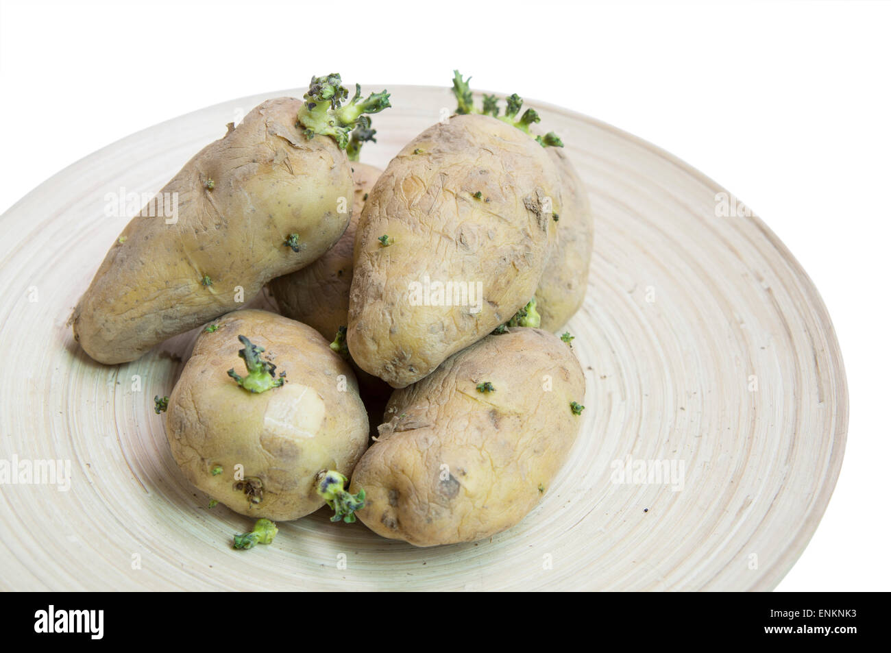 potatoes food raw uncooked plate wooden isolated Stock Photo - Alamy