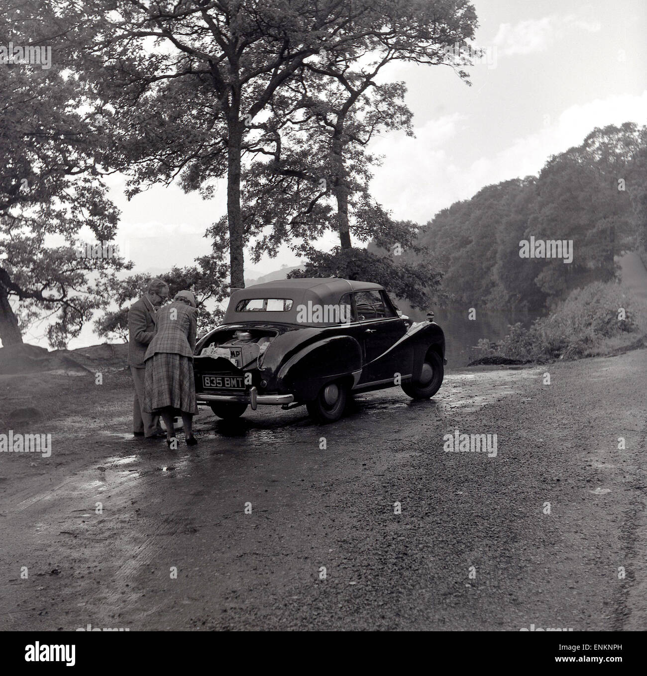 1950s, historical, couple on motoring holiday in their Morris A40 ...
