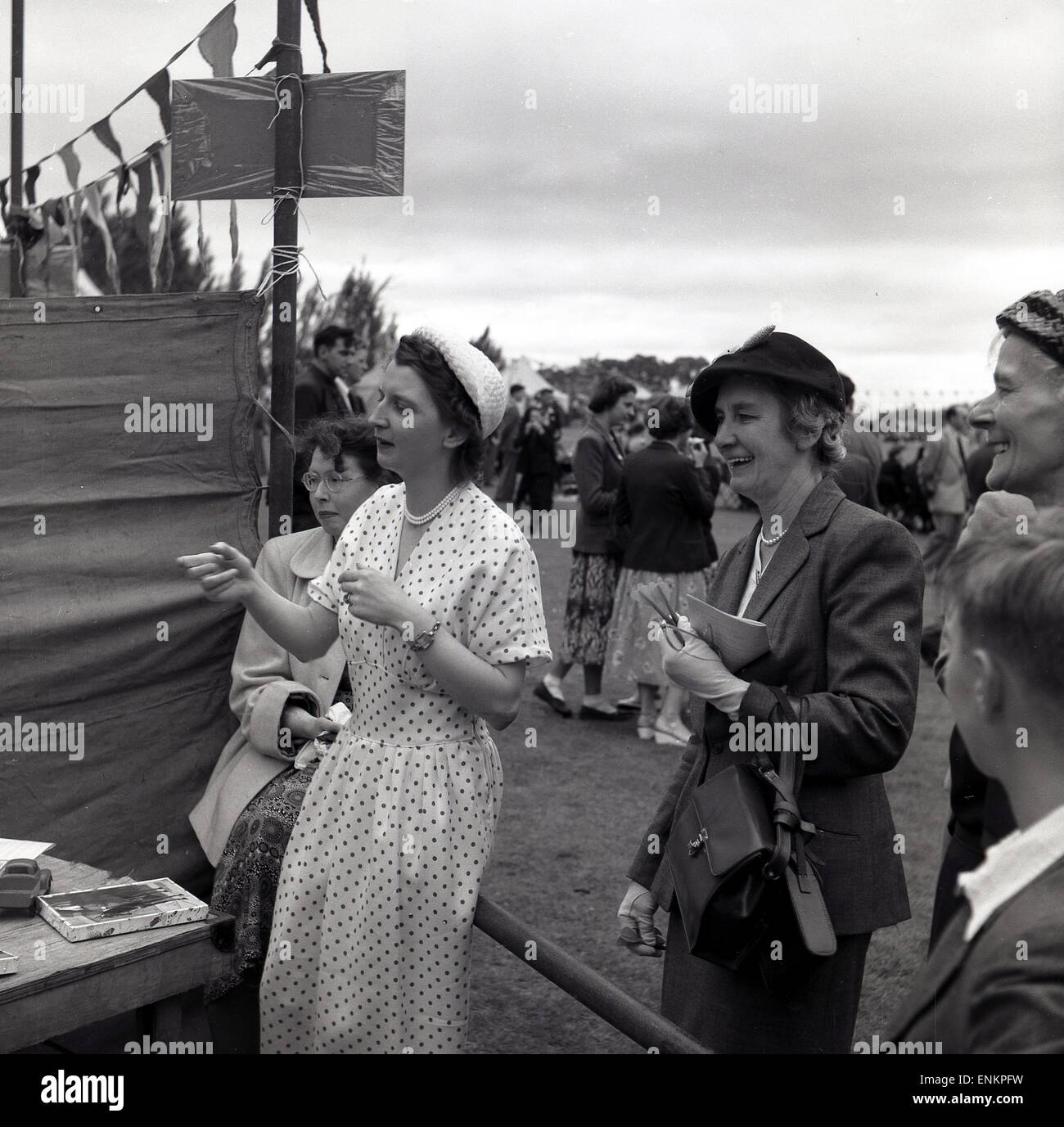 1950s, historical, dressed up for a fun day out, family at funfair ...