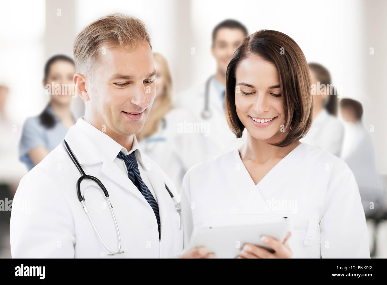 two doctors looking at tablet pc Stock Photo - Alamy