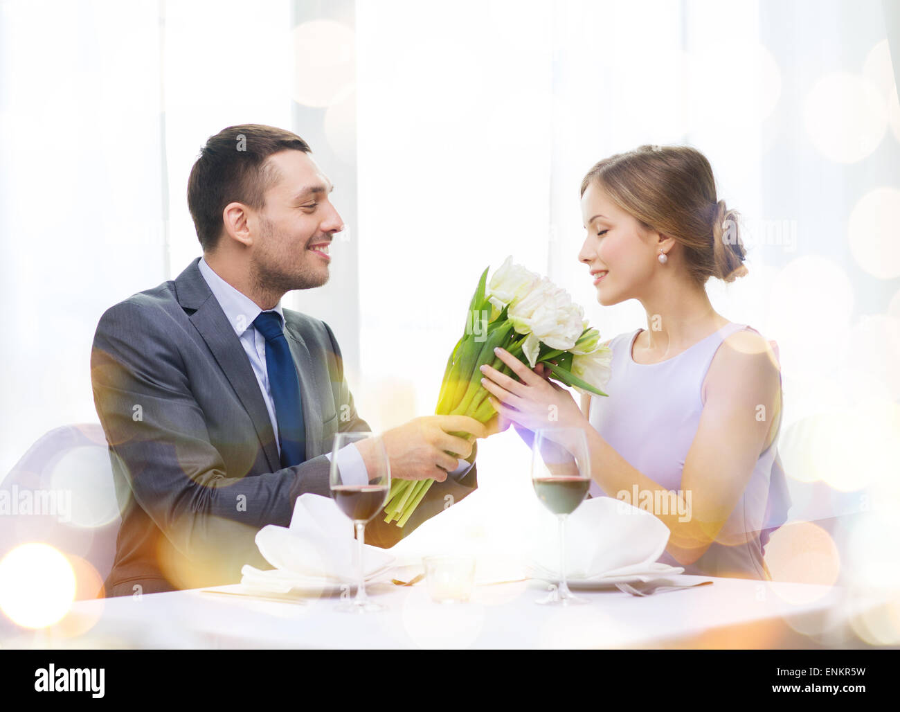 smiling man giving flower bouquet at restaurant Stock Photo - Alamy