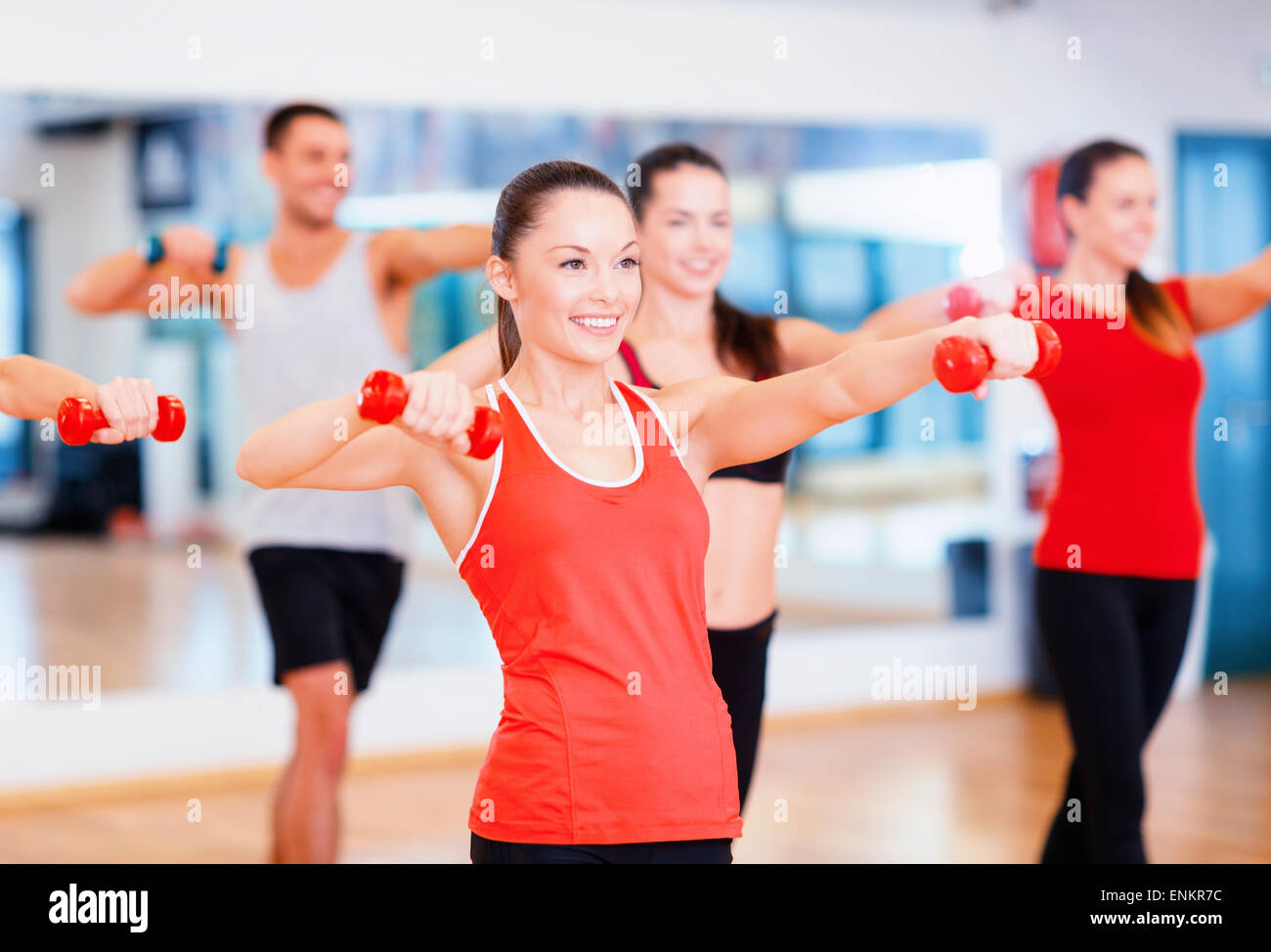 group of smiling people working out with dumbbells Stock Photo - Alamy