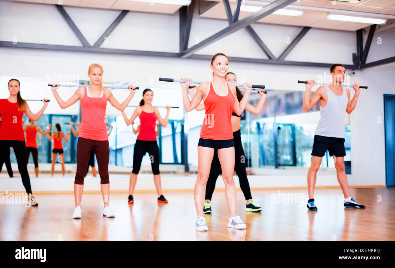group of smiling people working out with barbells Stock Photo - Alamy